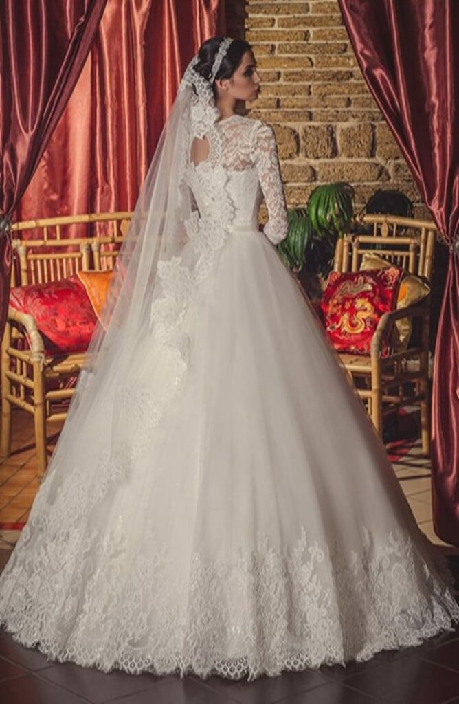 Pompous wedding dress with wide embroidered tulle skirt, three quarter ...